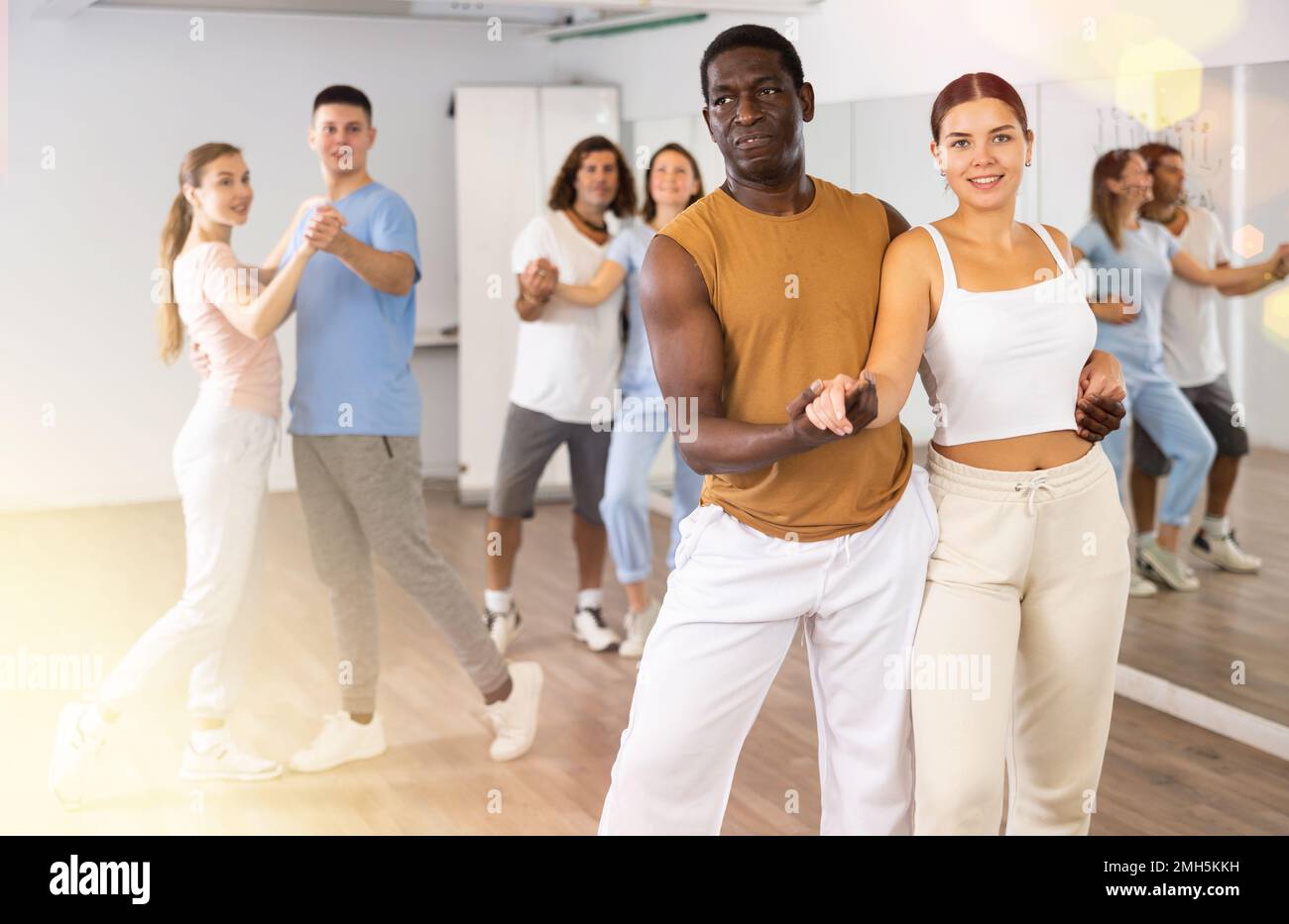 Group of different people rehearsing dance in dance studio Stock Photo ...