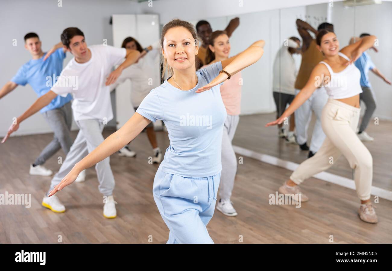 Group of different people rehearsing dance in dance studio Stock Photo ...