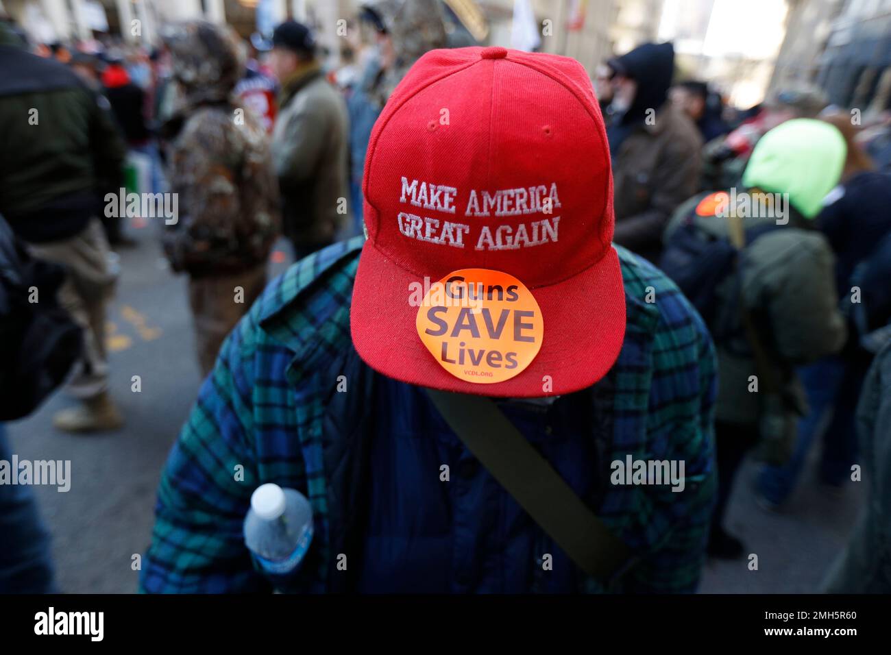 A man walks in the crowd during a pro-gun rally, Monday, Jan. 20, 2020 ...