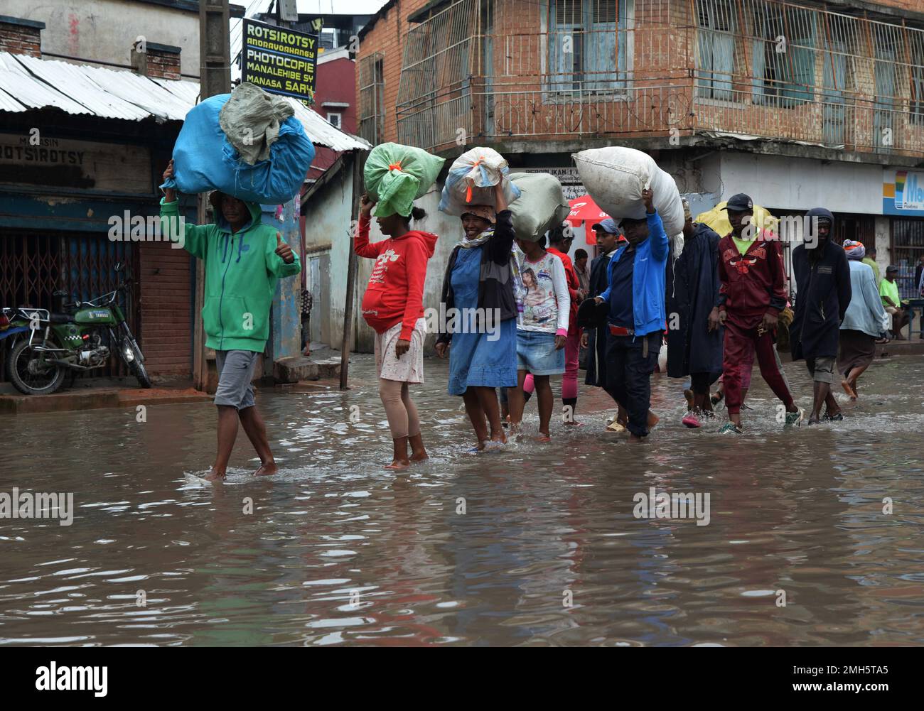 Antananarivo, Madagascar. 25th Jan, 2023. People walk on a flooded road ...