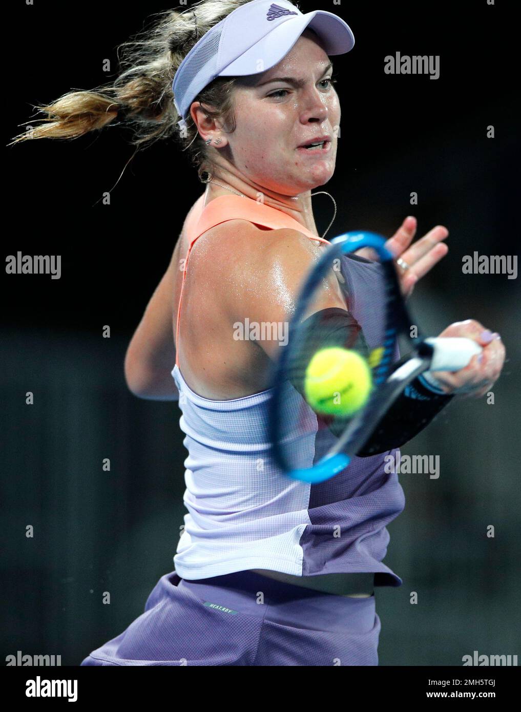 Catherine McNally of the United States makes a forehand return to ...