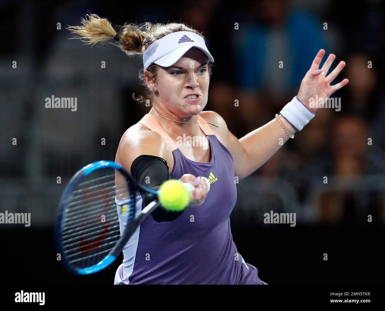 Catherine McNally of the United States makes a forehand return to ...