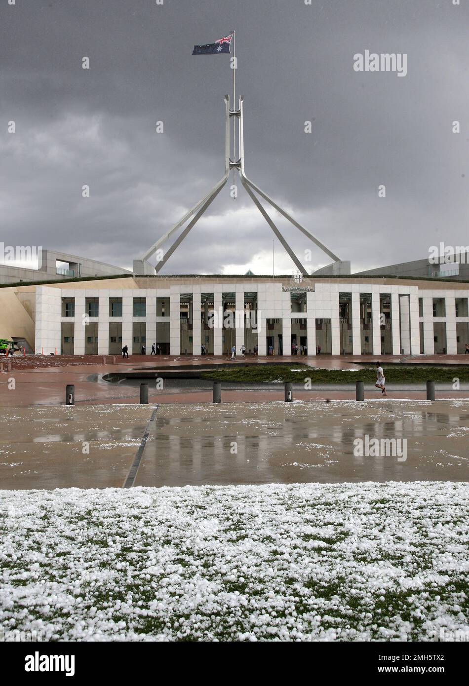 Golfball-sized hail carpet the lawn on the grounds of Parliament House ...
