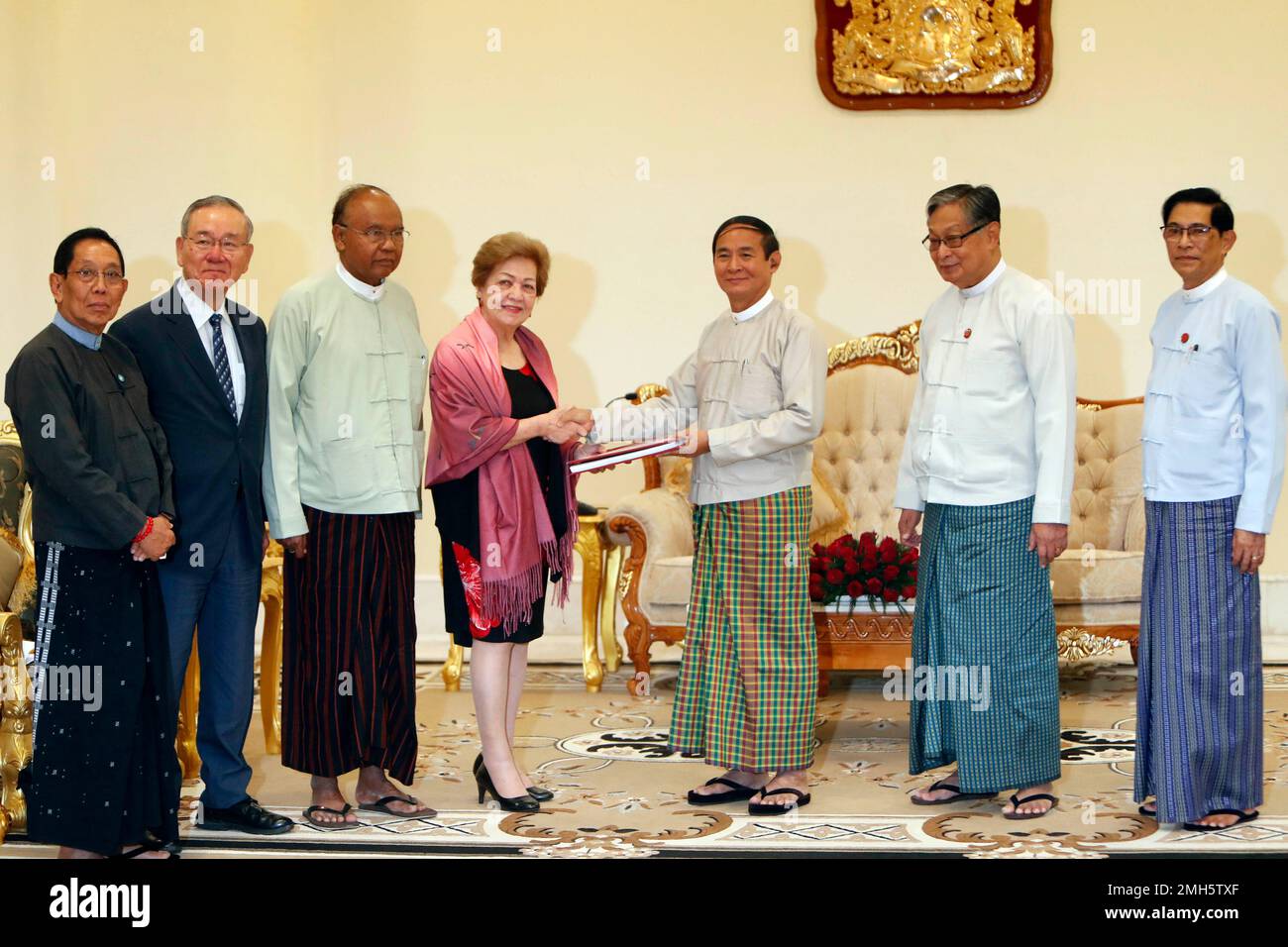 Myanmar's President Win Myint, center right, shakes hands with ...
