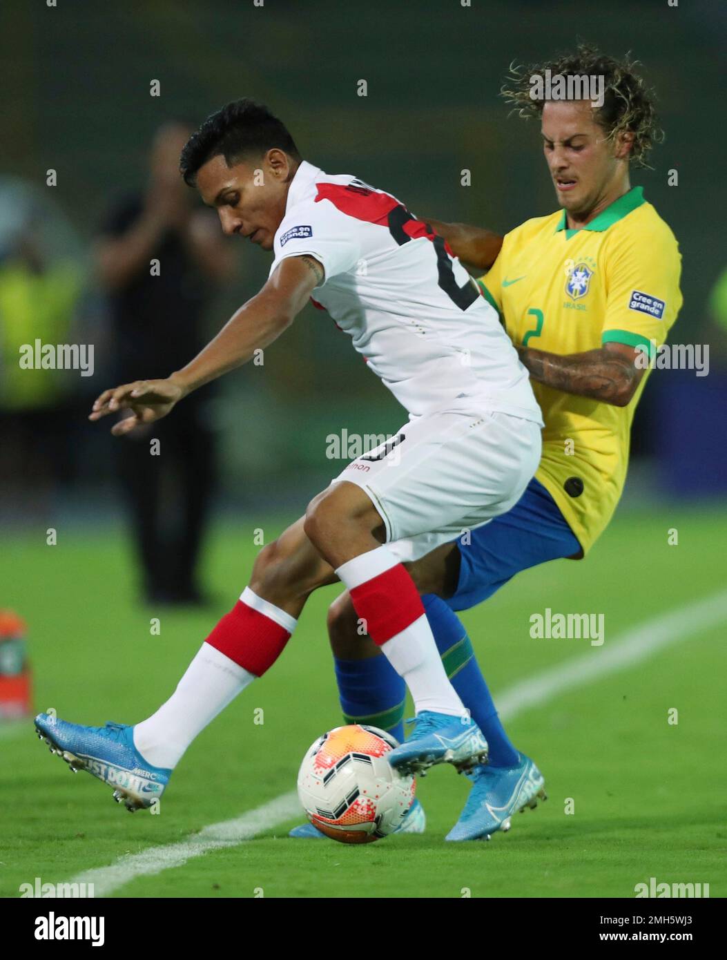 Peru's Kevin Sandoval, left, battles for the ball with Brazil's Guga ...