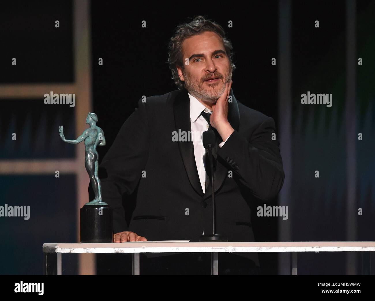 Joaquin Phoenix accepts the award for outstanding performance by a male ...