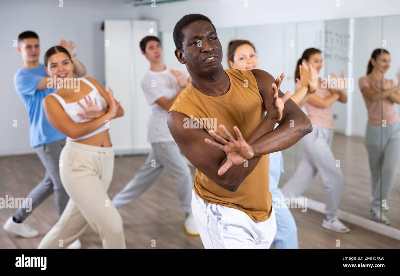 Happy multiracial men women of different ages performing dynamic ...