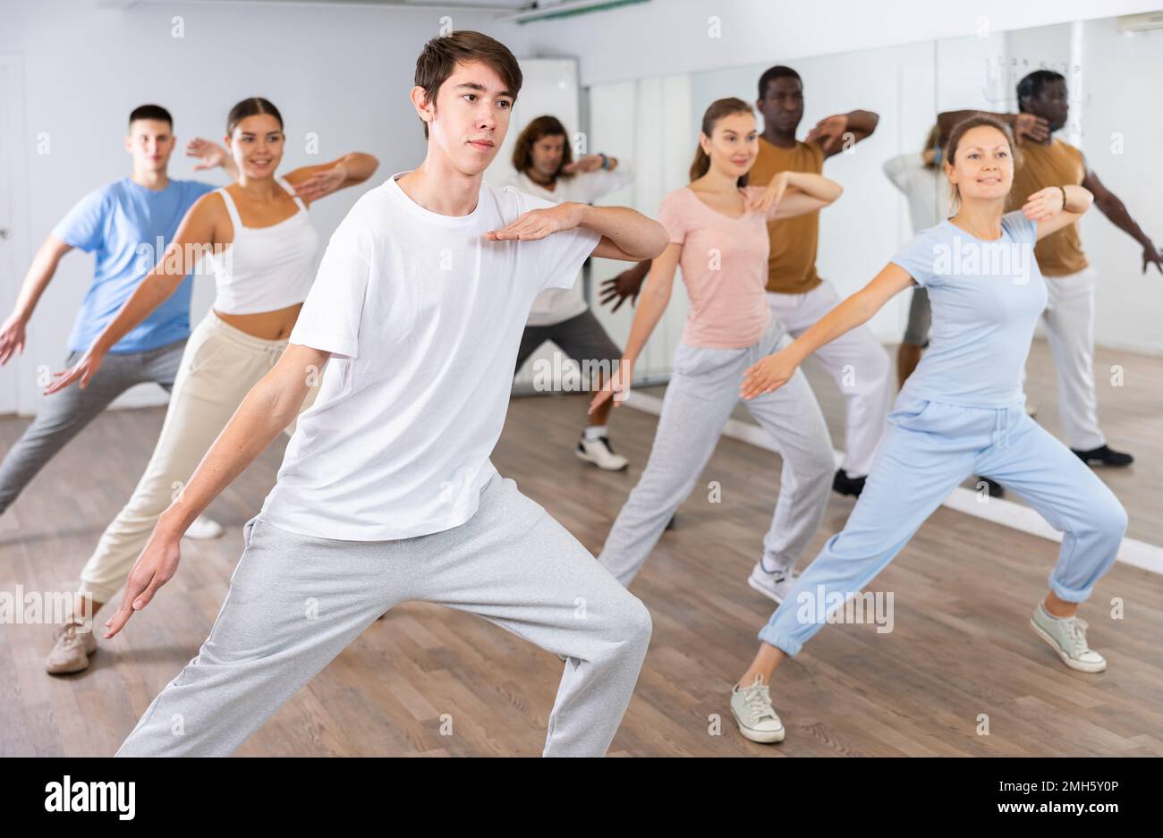 Group of different people rehearsing dance in dance studio Stock Photo ...