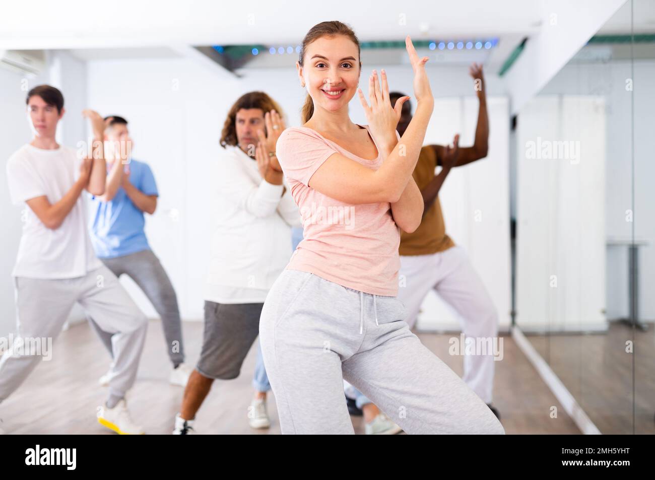 Group of different people rehearsing dance in dance studio Stock Photo ...