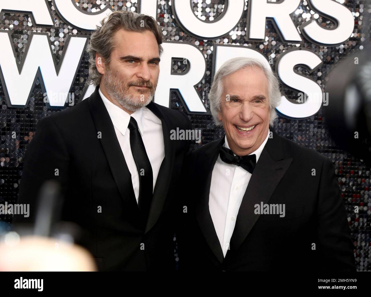 Joaquin Phoenix, left, and Henry Winkler arrive at the 26th annual ...