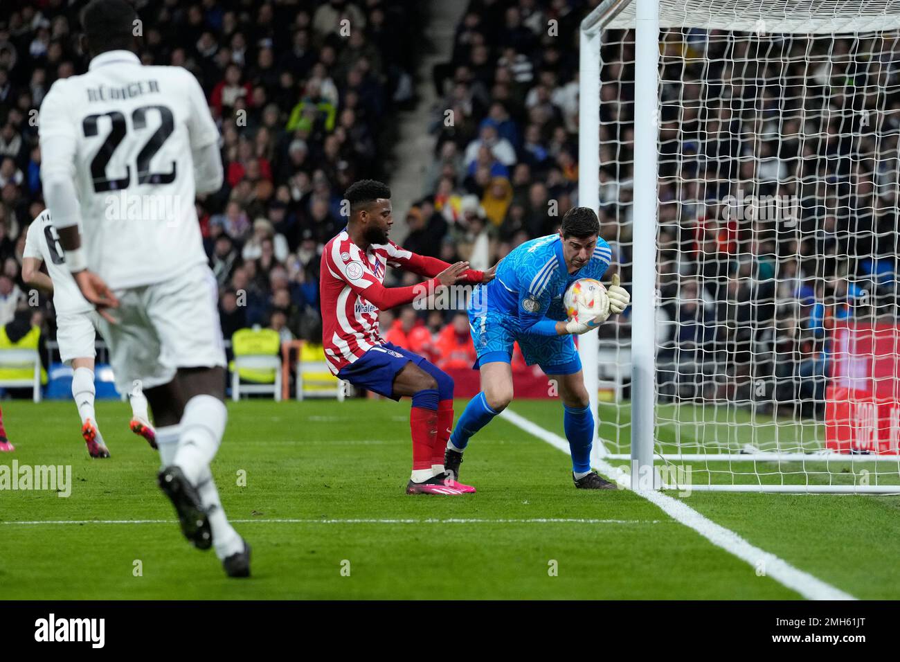 Real Madrid's goalkeeper Thibaut Courtois, right, catches the ball next ...