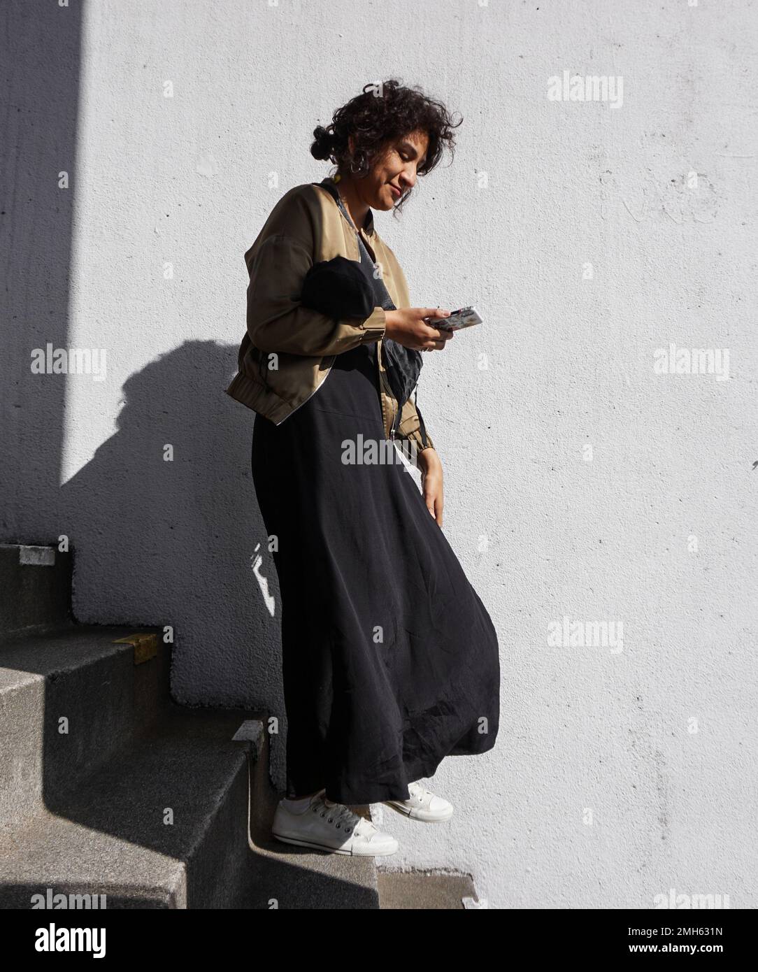 Woman standing on steps hi-res stock photography and images - Alamy