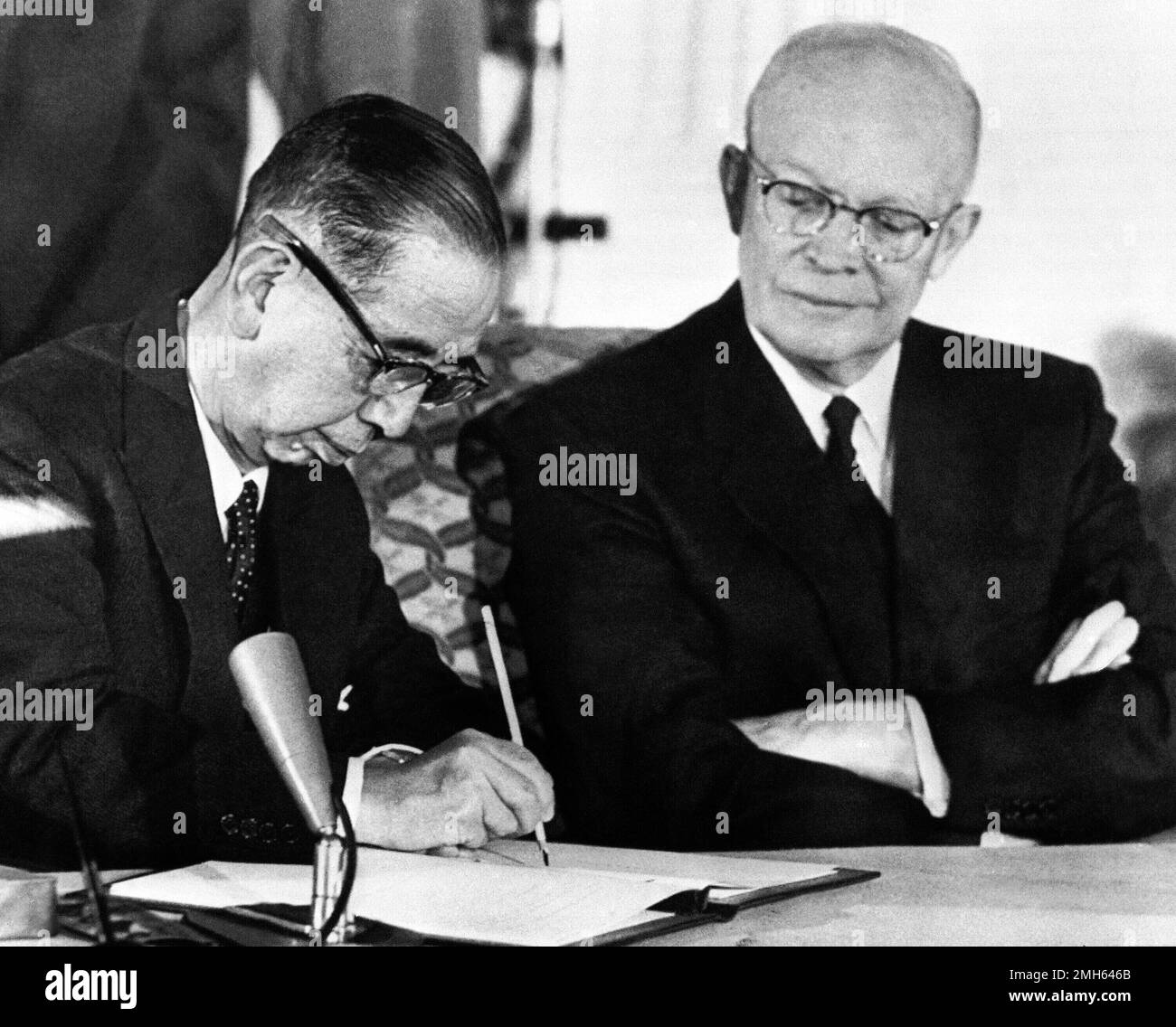 Japanese Prime Minister Nobusuke Kishi signs a treaty of mutual ...