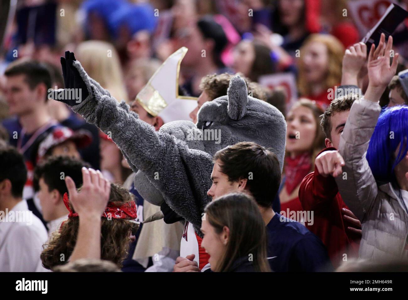 Gonzaga mascot Spike the Bulldog, center, stands with fans in the ...