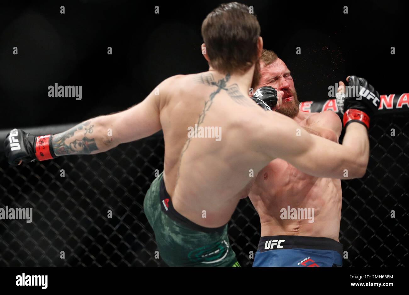 Conor McGregor kicks Donald "Cowboy" Cerrone during a UFC 246 ...