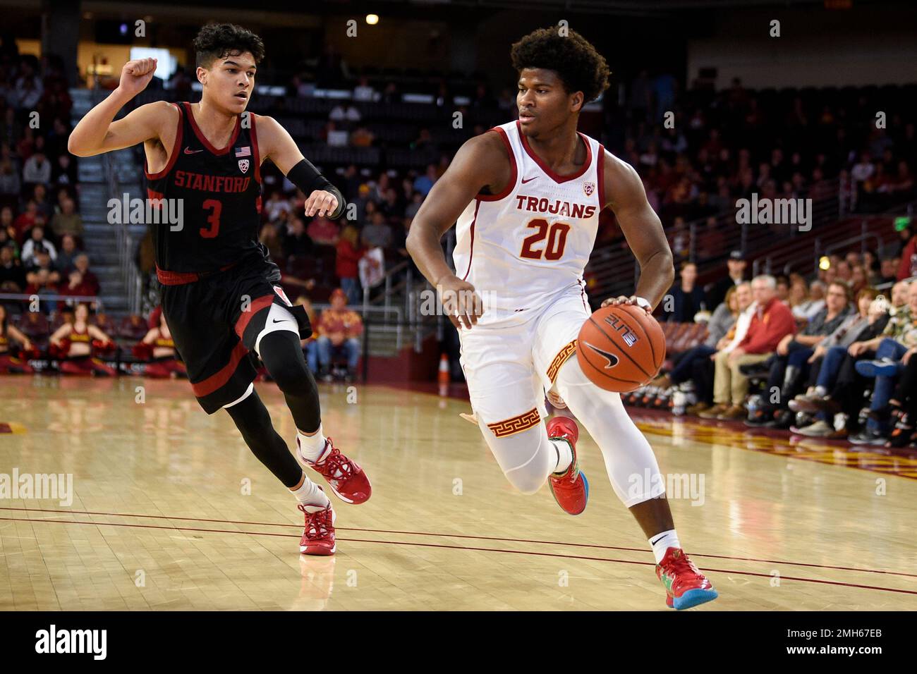 Southern California guard Ethan Anderson, right, drives to the basket ...
