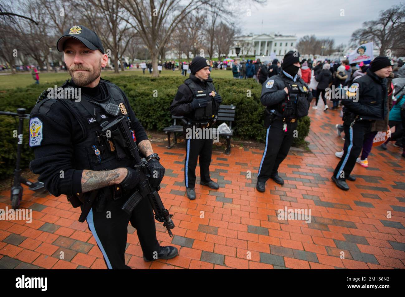 Park Police officer Robert Welsted, left, watch as participants of the ...