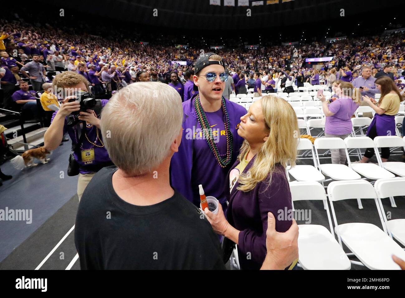 LSU quarterback Joe Burrow greets his parents Jimmy and Robin Burrow ...