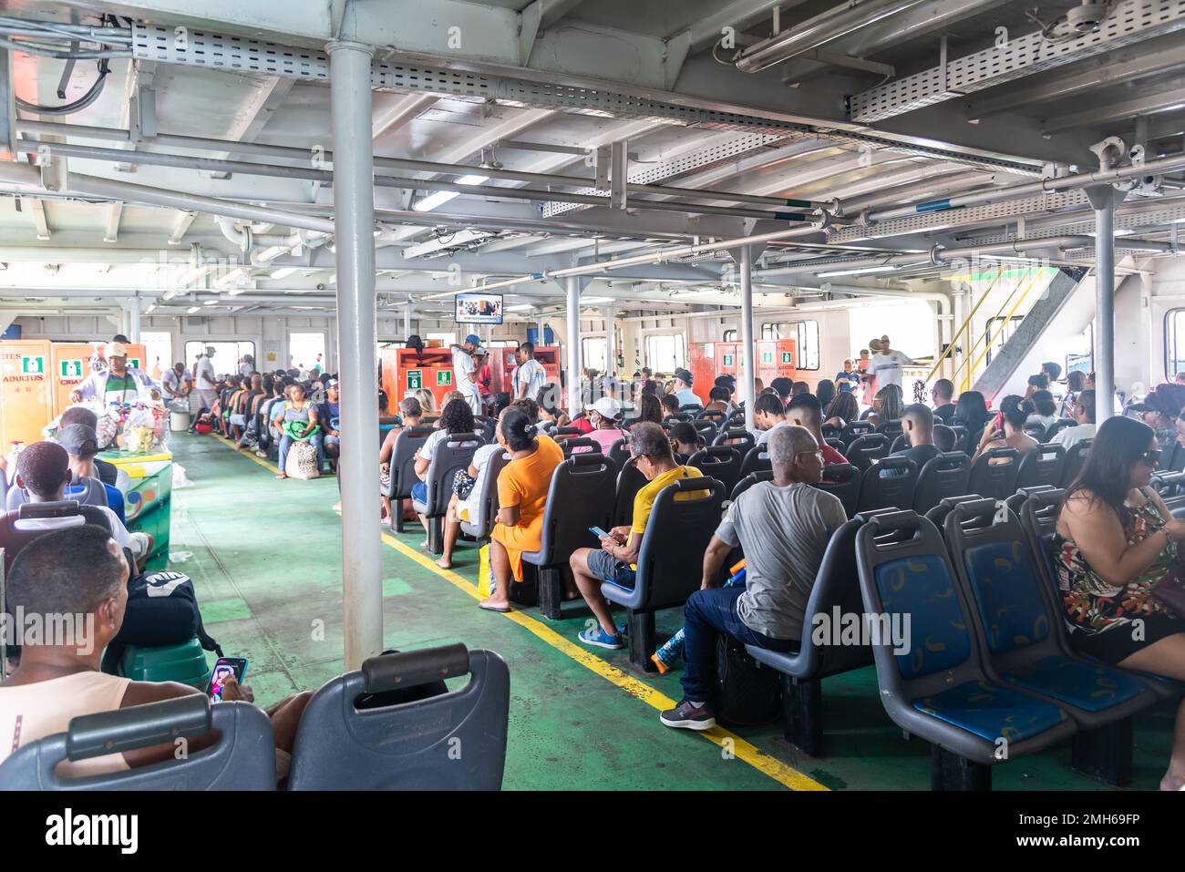 Itaparica, Bahia, Brazil - January 24, 2023: Many passengers sitting inside the Ferry-Boat in ...