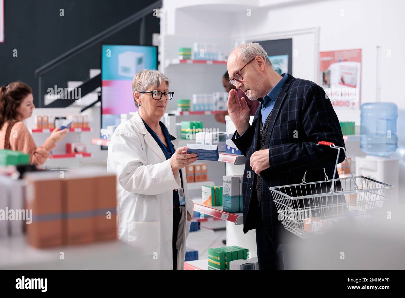 Drugstore employee helping customer with pharmaceutical treatment ...