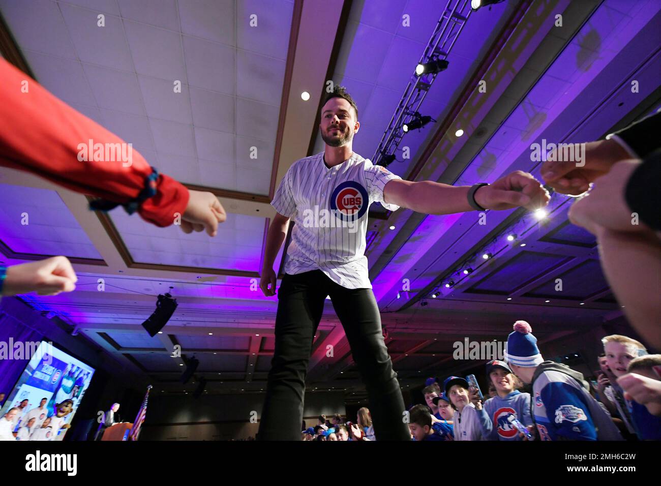 Chicago Cubs' Kris Bryant fist-bumps fans after being announced during ...
