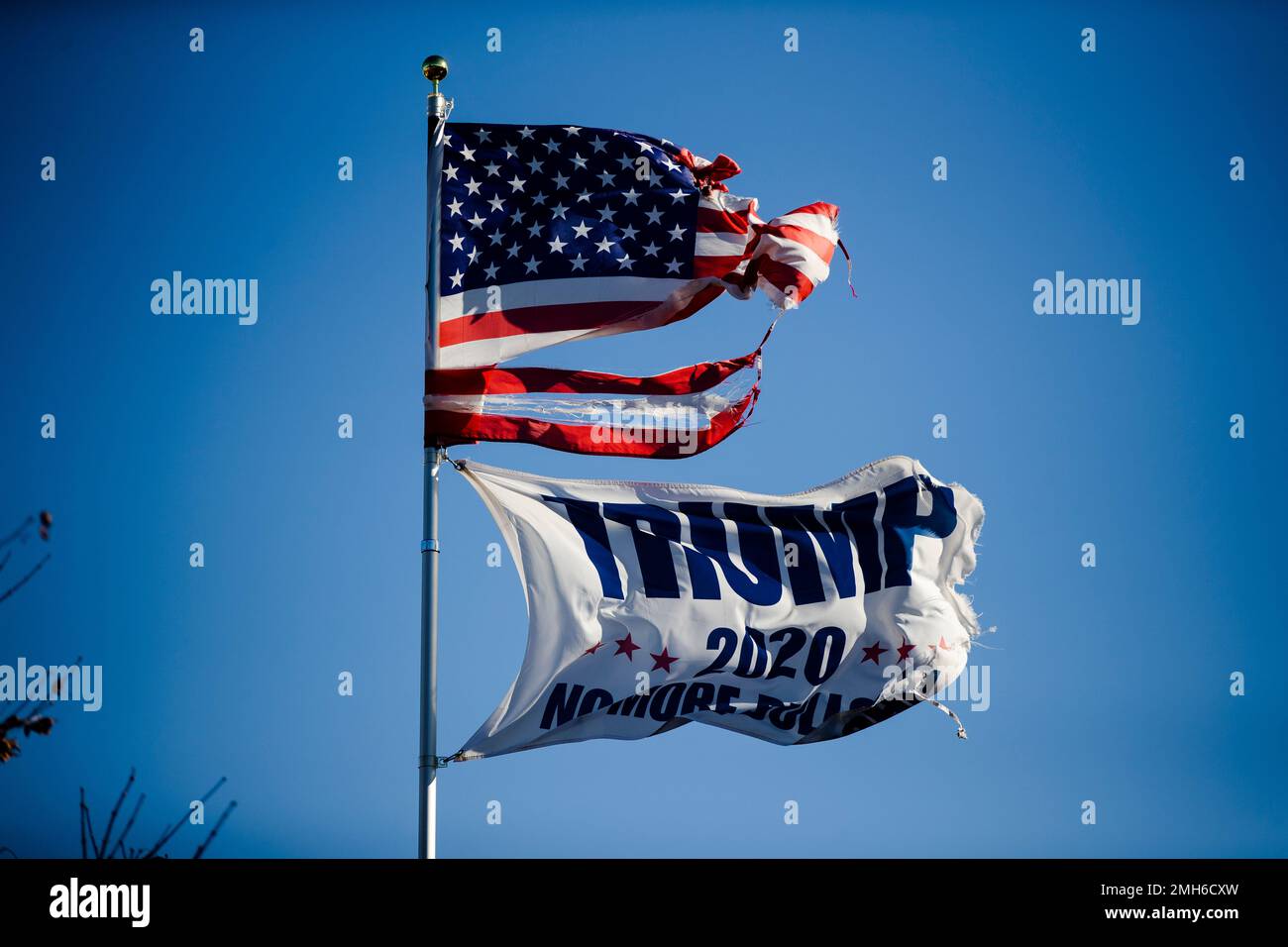 A United States and a President Donald Trump flags wave in the wind in ...