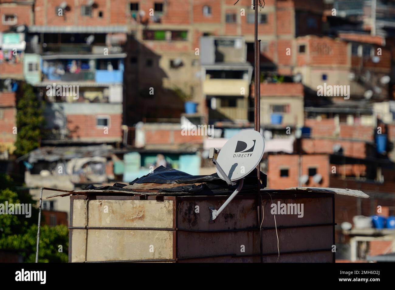 A DirecTV dish stands on the roof of a home in the Catia neighborhood ...