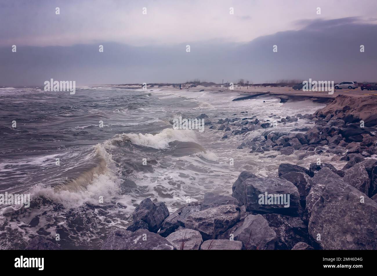 Waves crash on a nearly deserted winter beach at Dauphin Island West ...