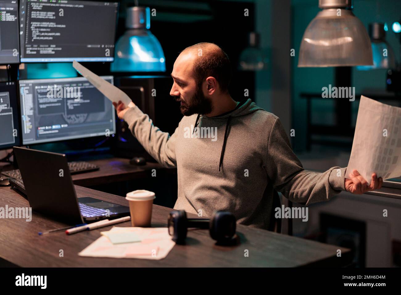 Frustrated software developer working late at night, feeling under ... Frustrated software developer working late at night, feeling under ...