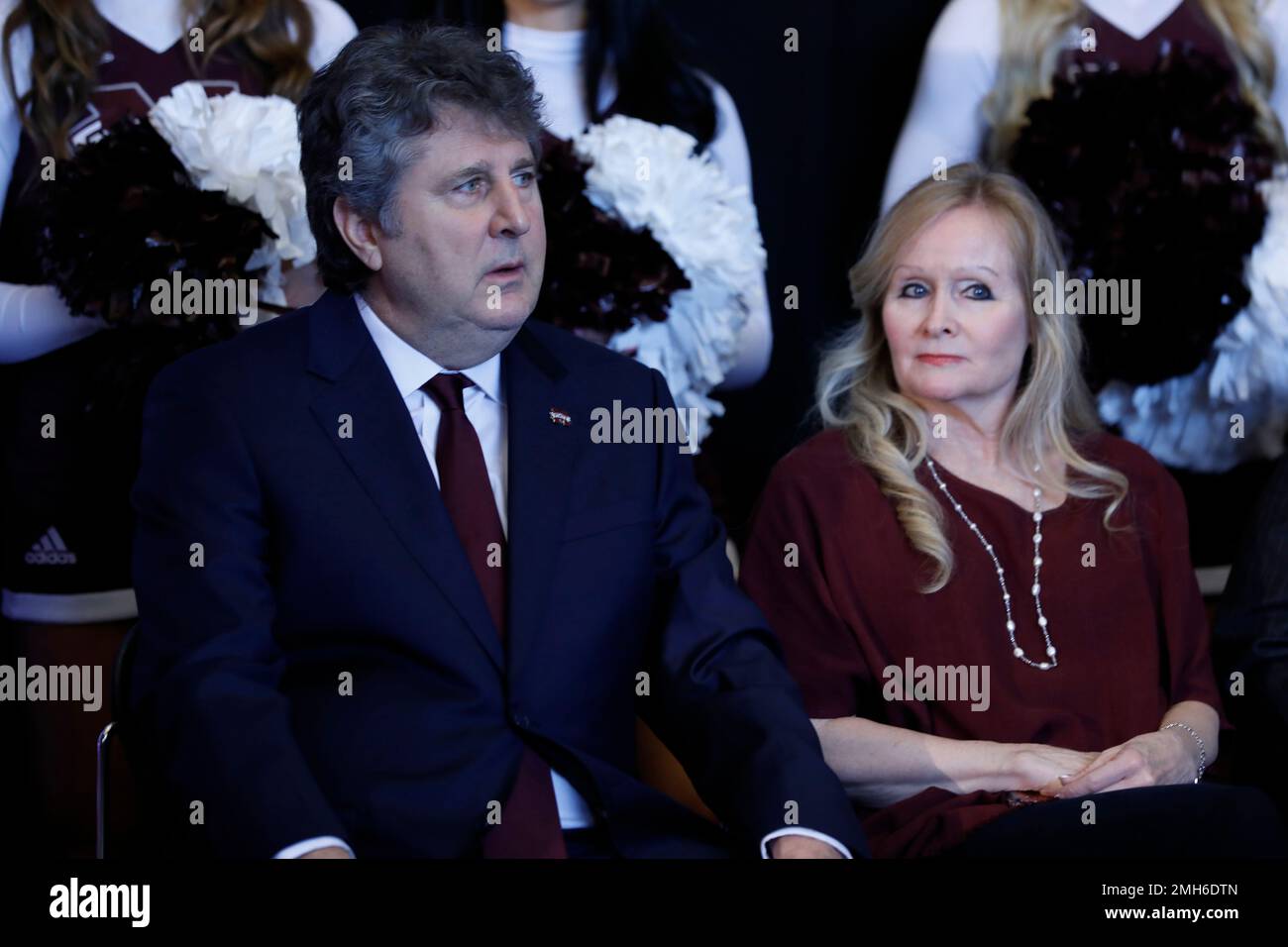 Mike Leach, left and his wife Sharon Leach, listen as he is introduced ...
