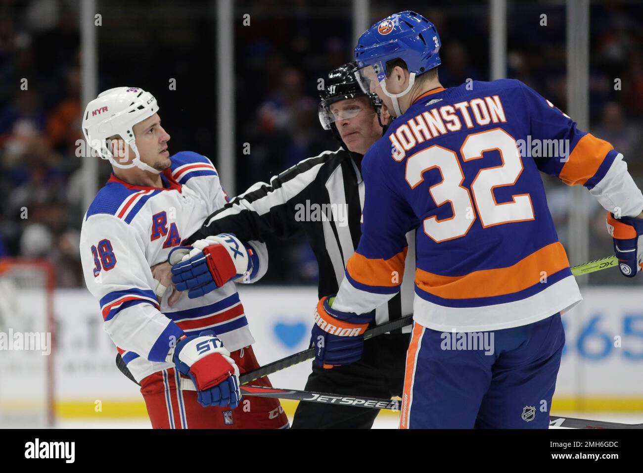 A referee separates New York Rangers' Micheal Haley (38) and New York ...