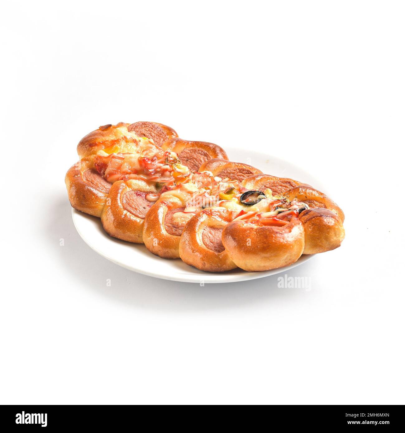 Twisted sausage bread is made of sausage slices and cheese. It is then ...