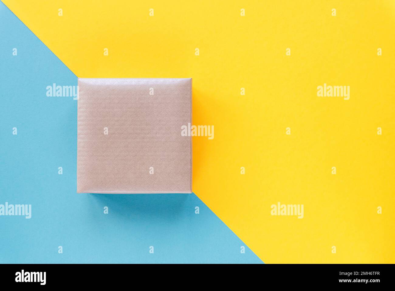 Gray box on yellow and blue background. Top view, flat lay, mockup ...