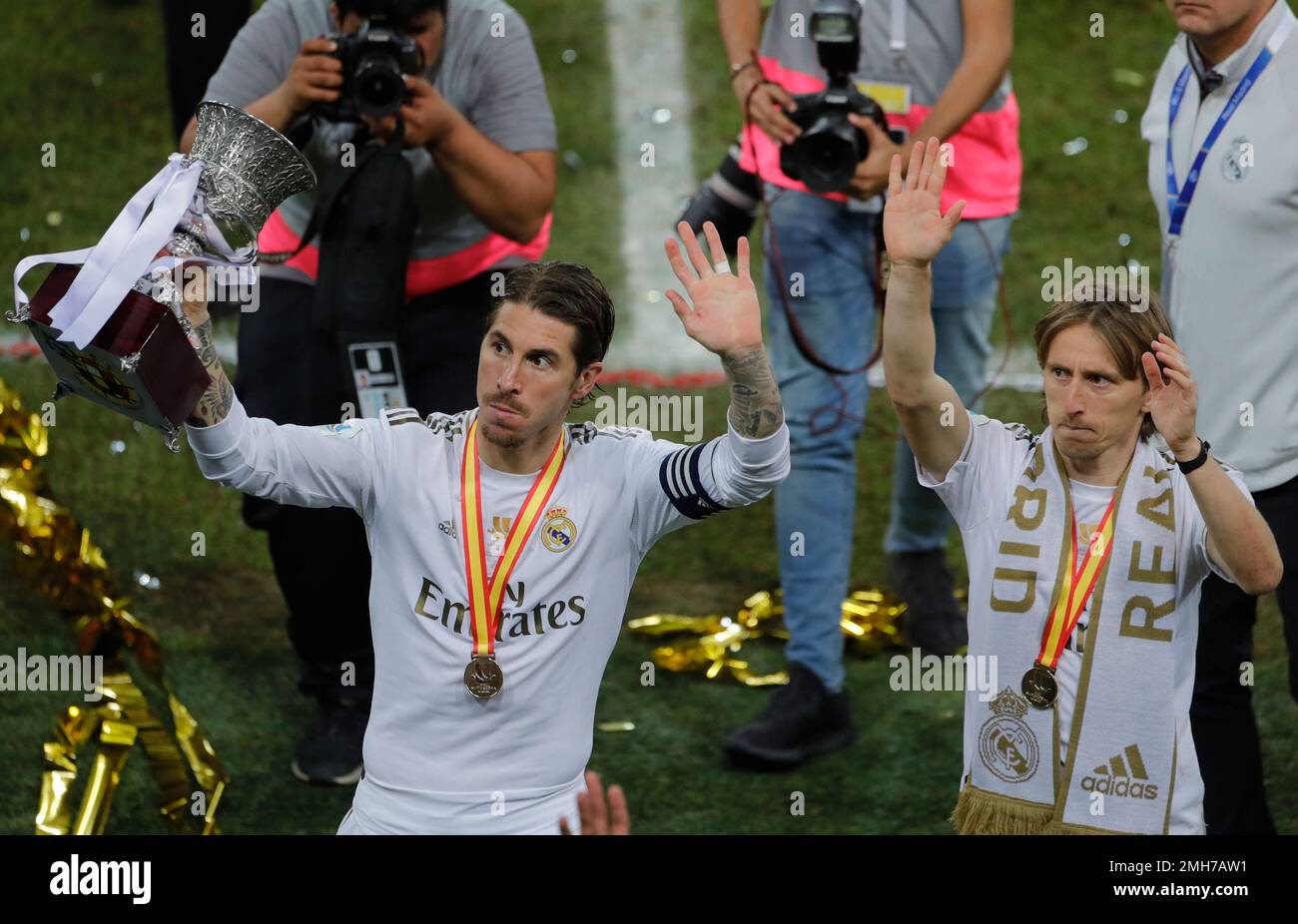 Real Madrid's Sergio Ramos celebrates with the trophy next to Luka ...