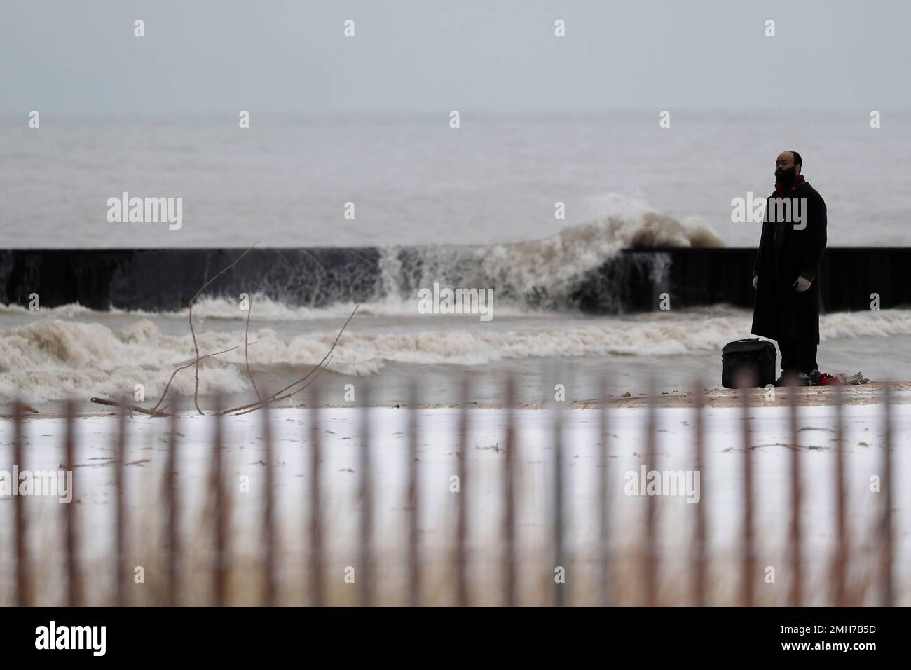 A man looks to the Lake Michigan at Clark Street Beach in Evanston, Ill ...