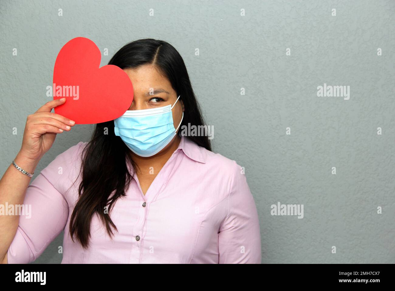 Valentine's Day latin woman with red heart Stock Photo - Alamy