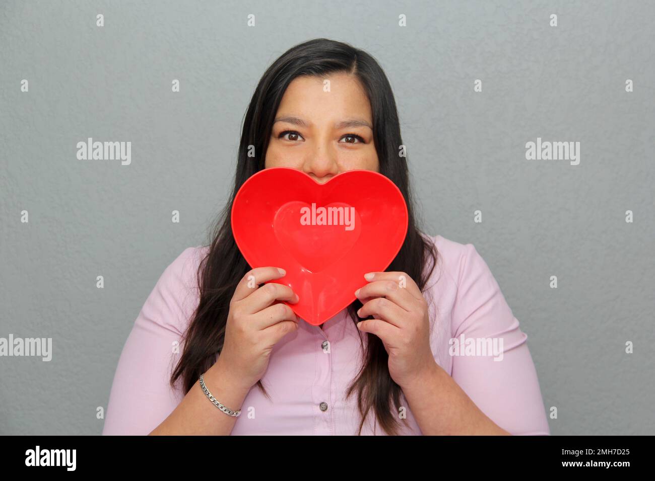 Valentine's Day latin woman with red heart Stock Photo - Alamy