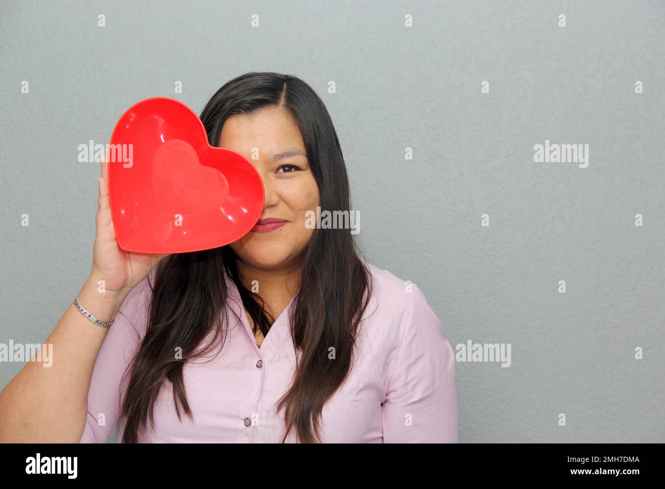 Valentine's Day latin woman with red heart Stock Photo - Alamy