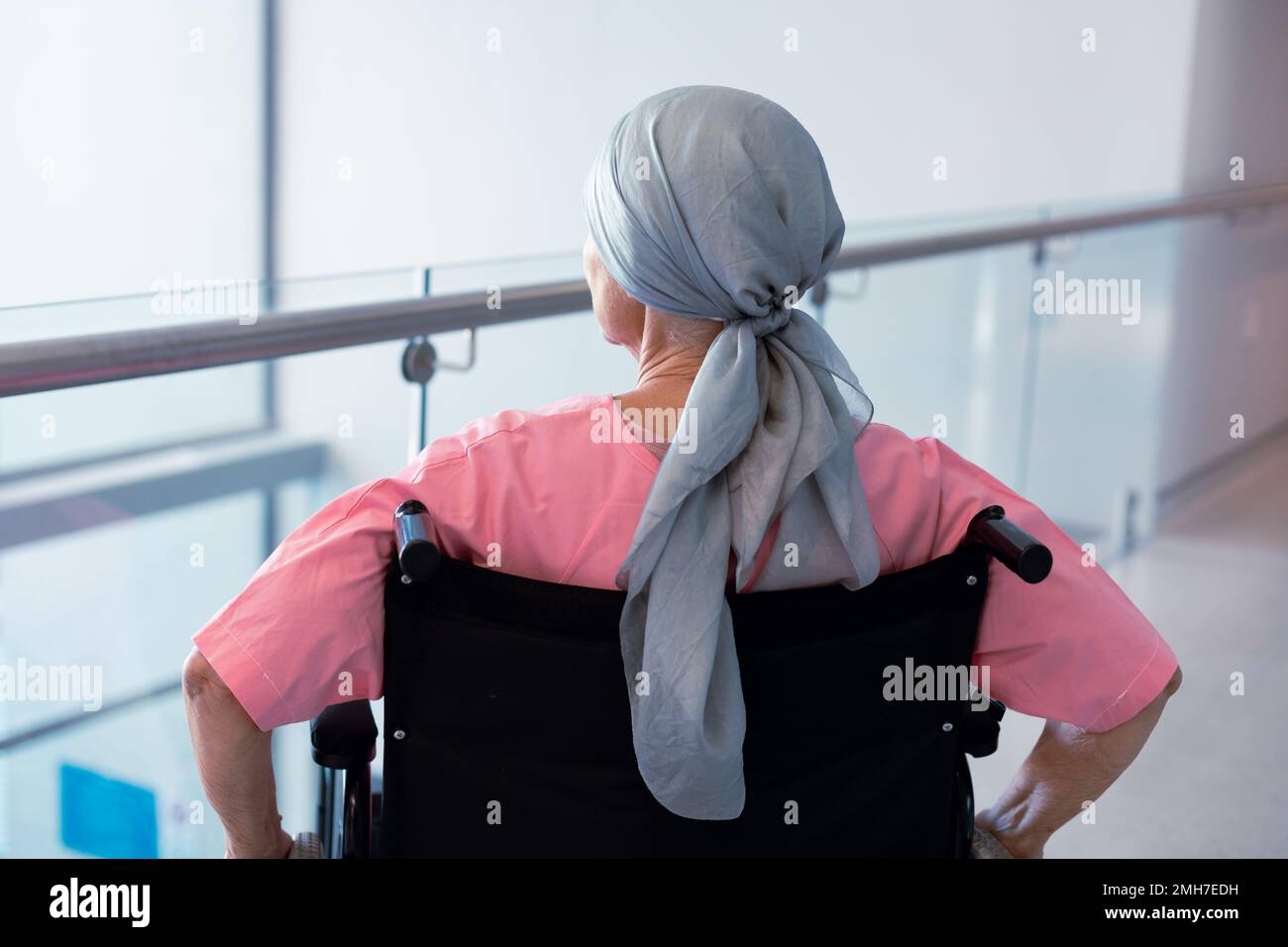 Senior caucasian female cancer patient wearing head scarf sitting in ...