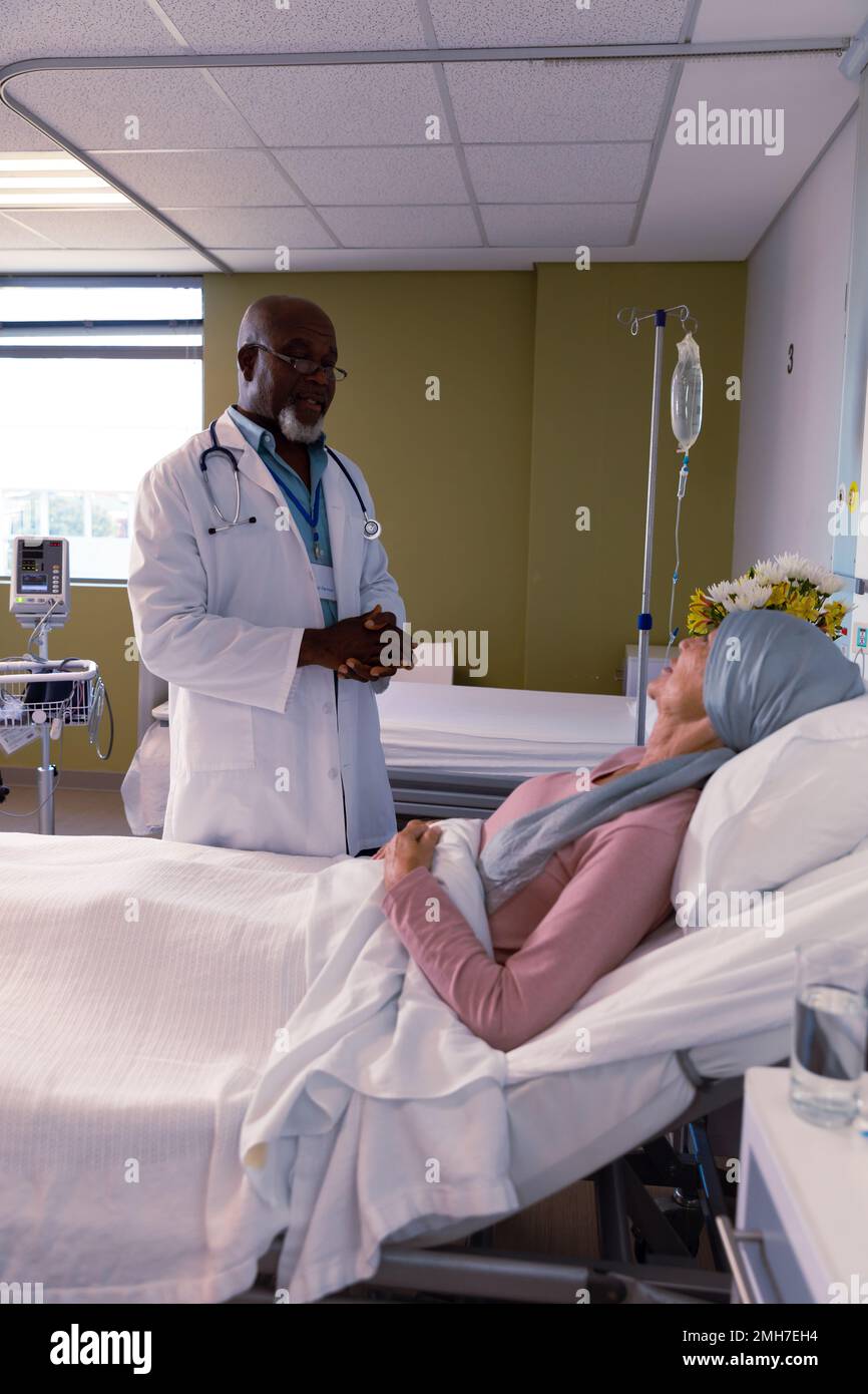 African american male doctor visiting senior caucasian female cancer ...