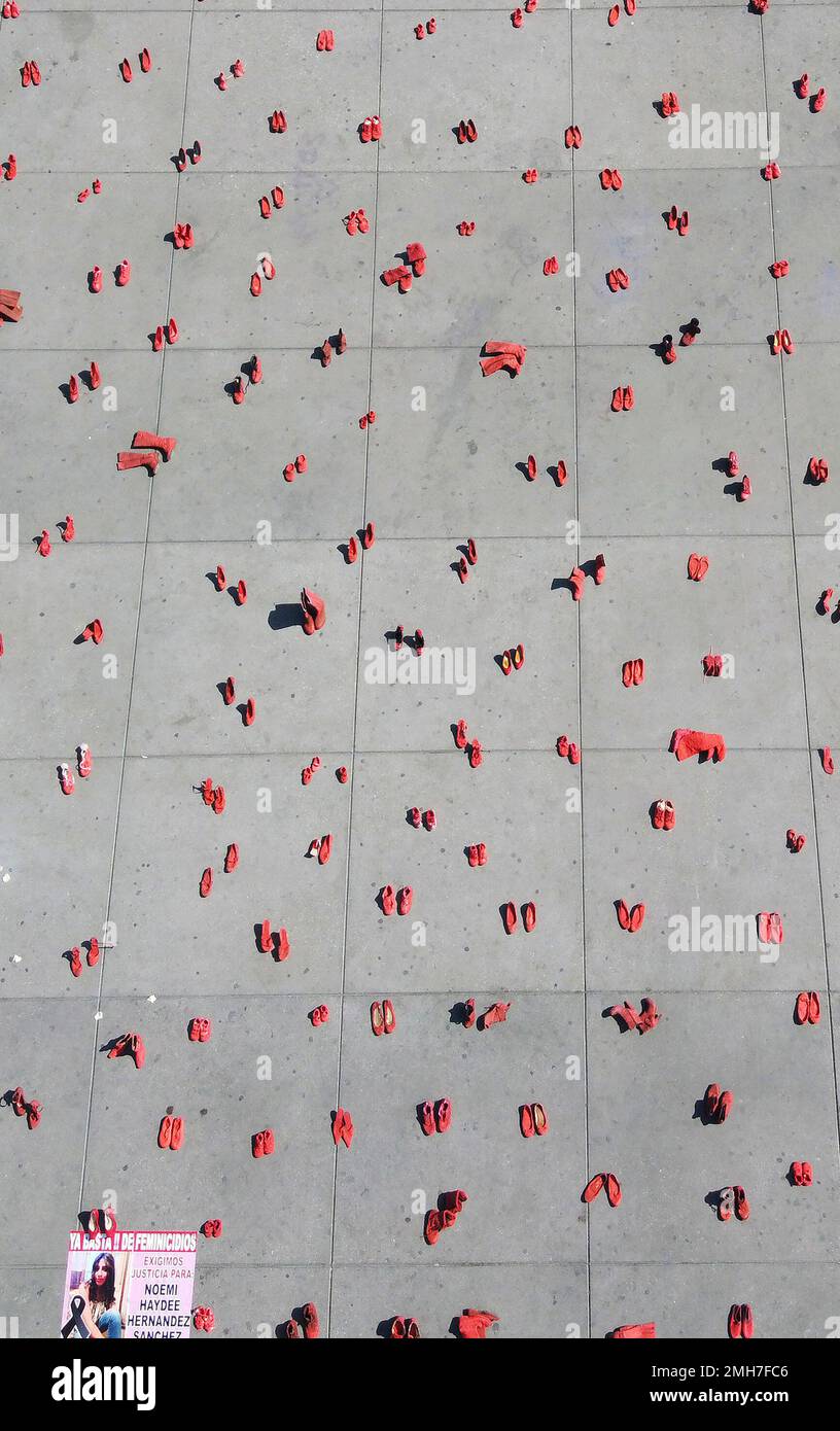 Women's red shoes are spread out in the Zocalo where they were placed ...