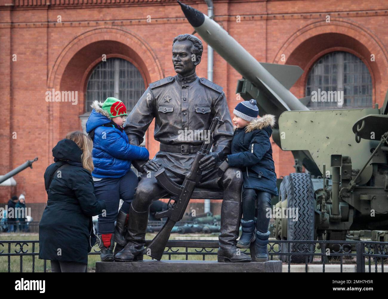 Children climb on a statue of Russian firearm designer Mikhail ...