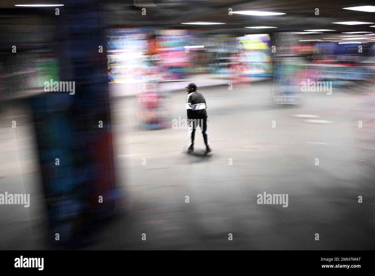 A man is seen skateboarding in the Southbank skate space by the river ...