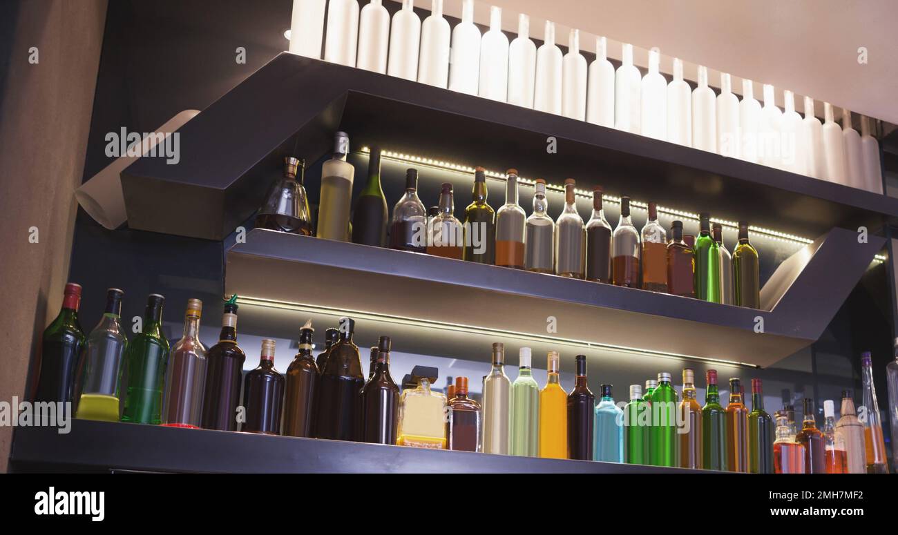 Image of rows of bottles on shelves in bar Stock Photo - Alamy