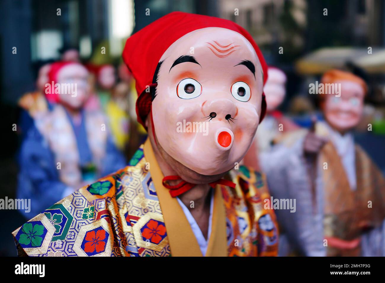 Artists wearing Japanese traditional clown masks stand for marching ...