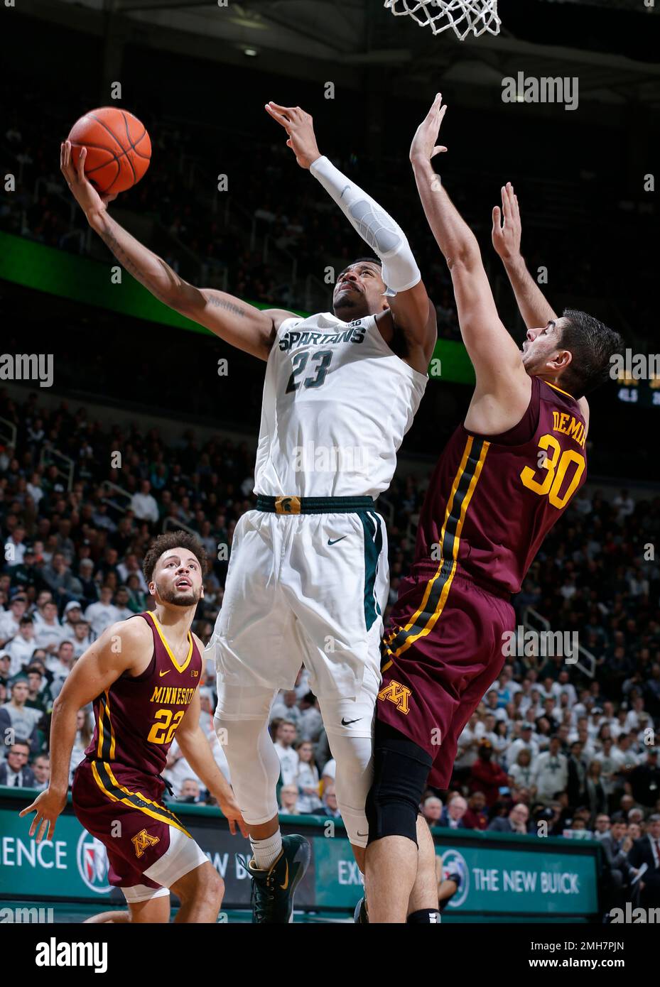 Michigan State's Xavier Tillman, left, shoots next to Minnesota's ...