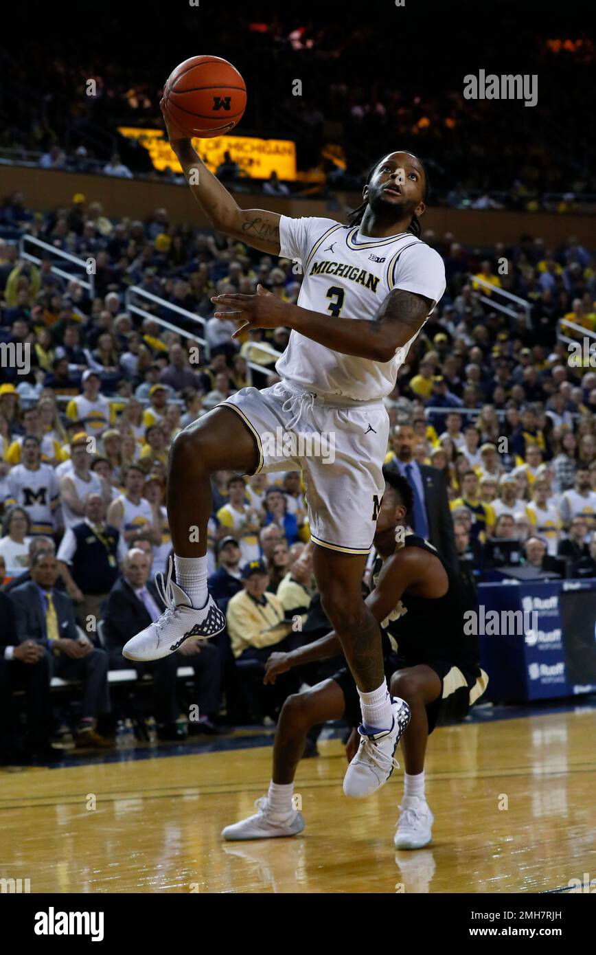 Michigan guard Zavier Simpson (3) drives past Purdue guard Eric Hunter ...