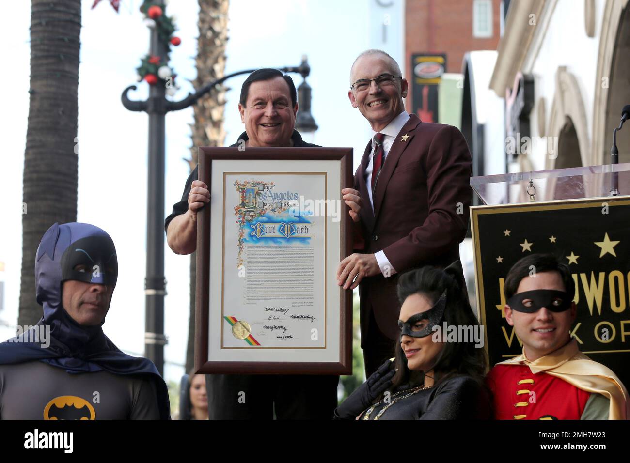 Burt Ward, left, and Mitch O'Farrell hold a recognition from the City ...