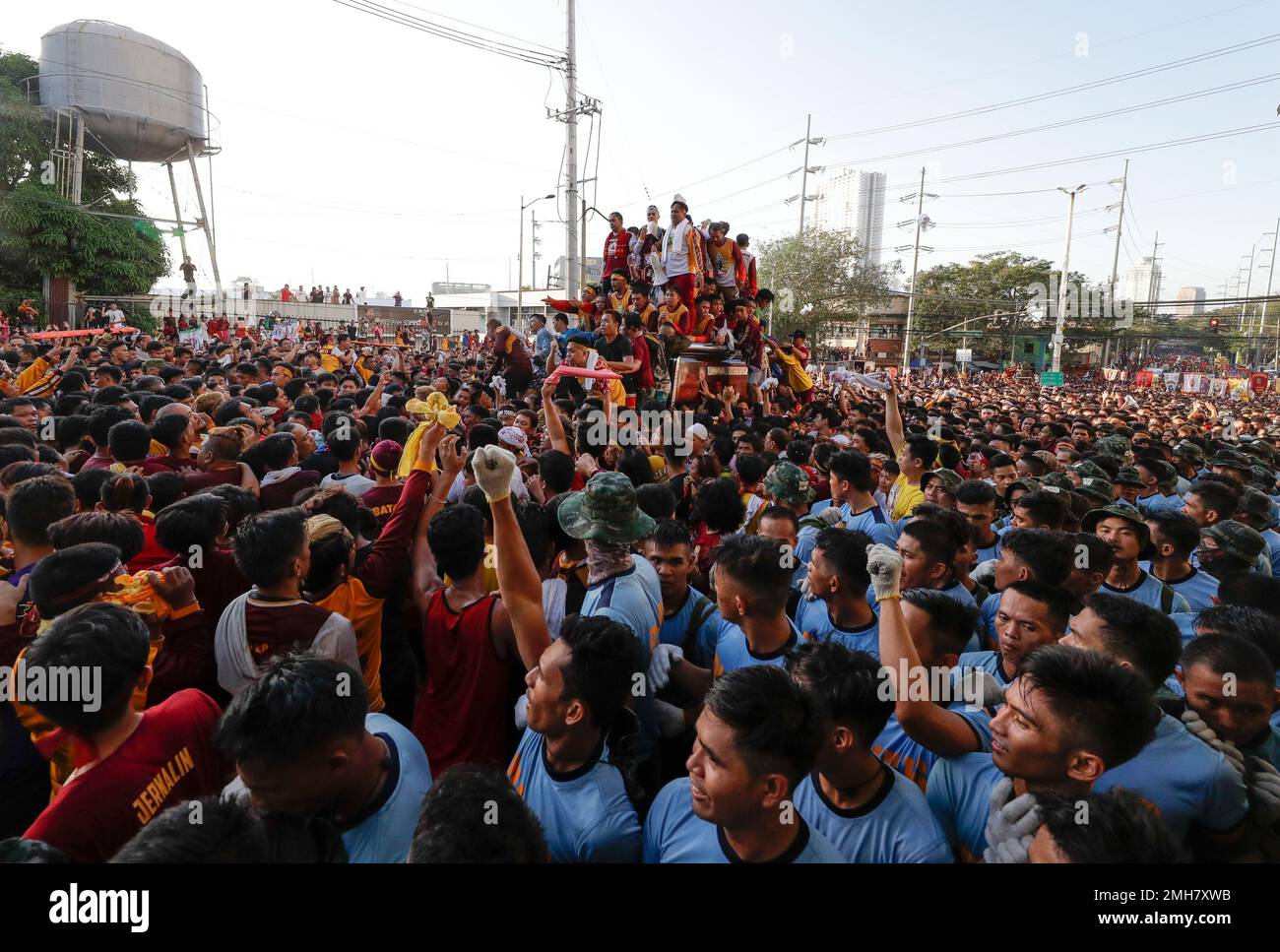 A crowd of Filipino Roman Catholic devotees follow the carriage of the ...