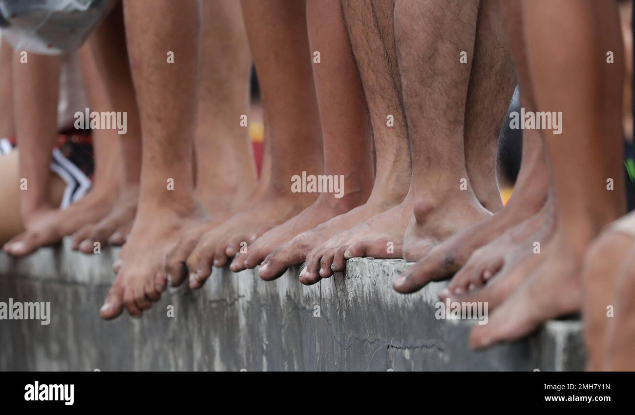 Barefoot devotees join the raucous procession to celebrate the feast ...